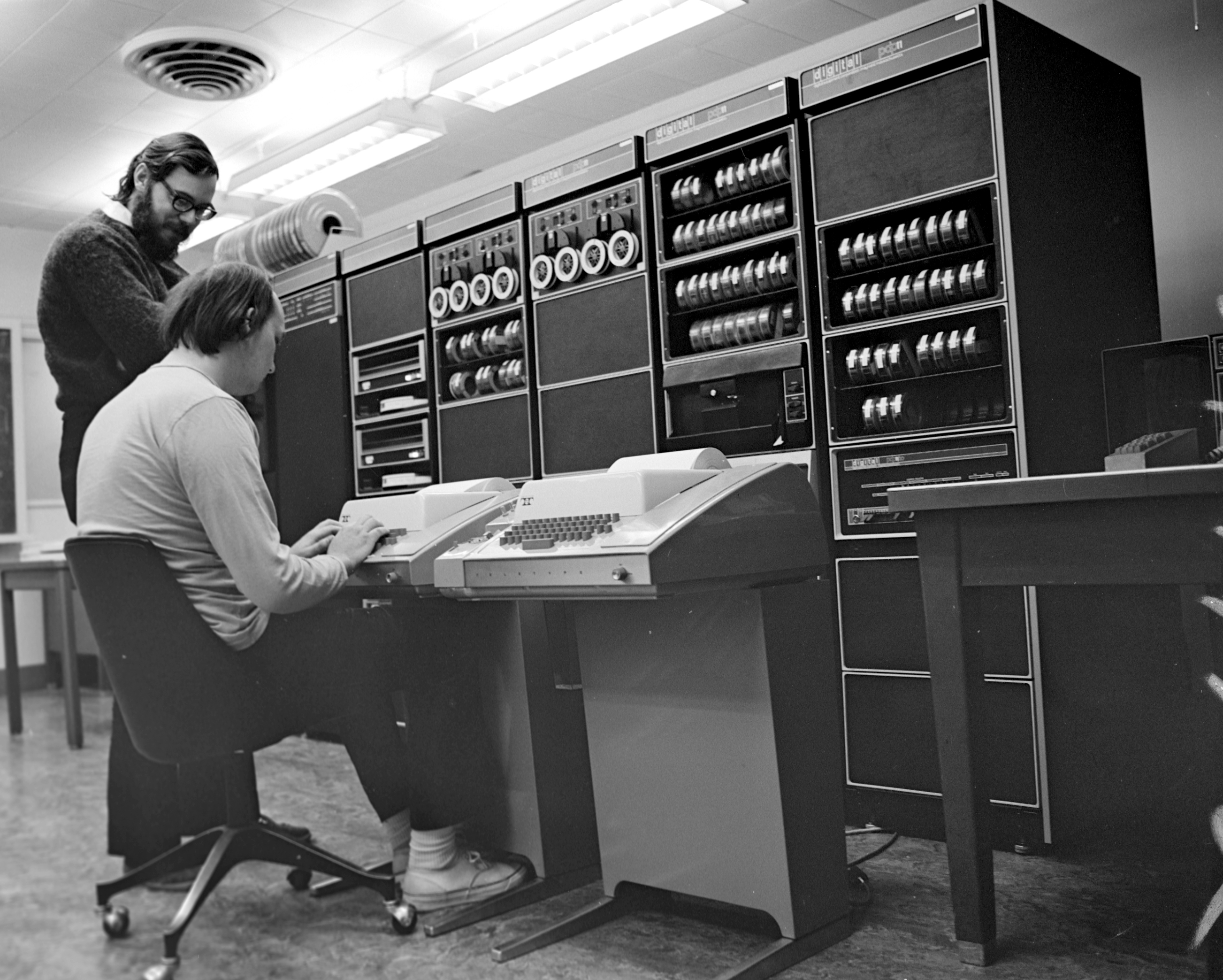 Dennis Richie and Brian Kernighan using a PDP-11 - MyConfinedSpace
