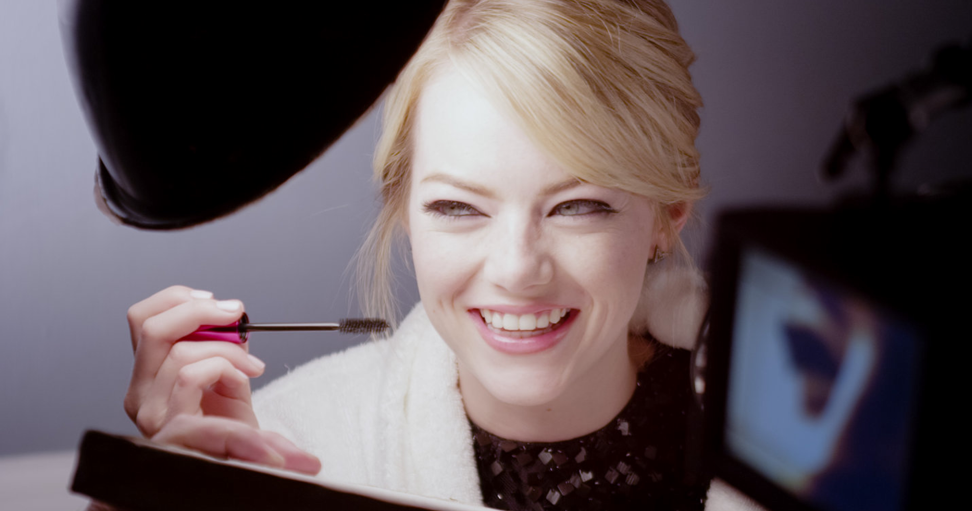 Emma Stone applying make up to her already perfect face all the while ...