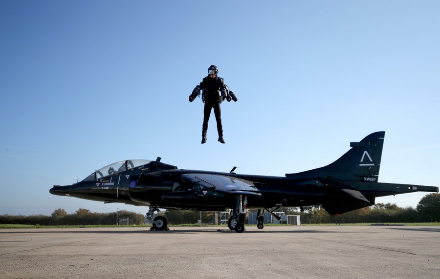 jet man mocking a real jet with his jet hands - MyConfinedSpace