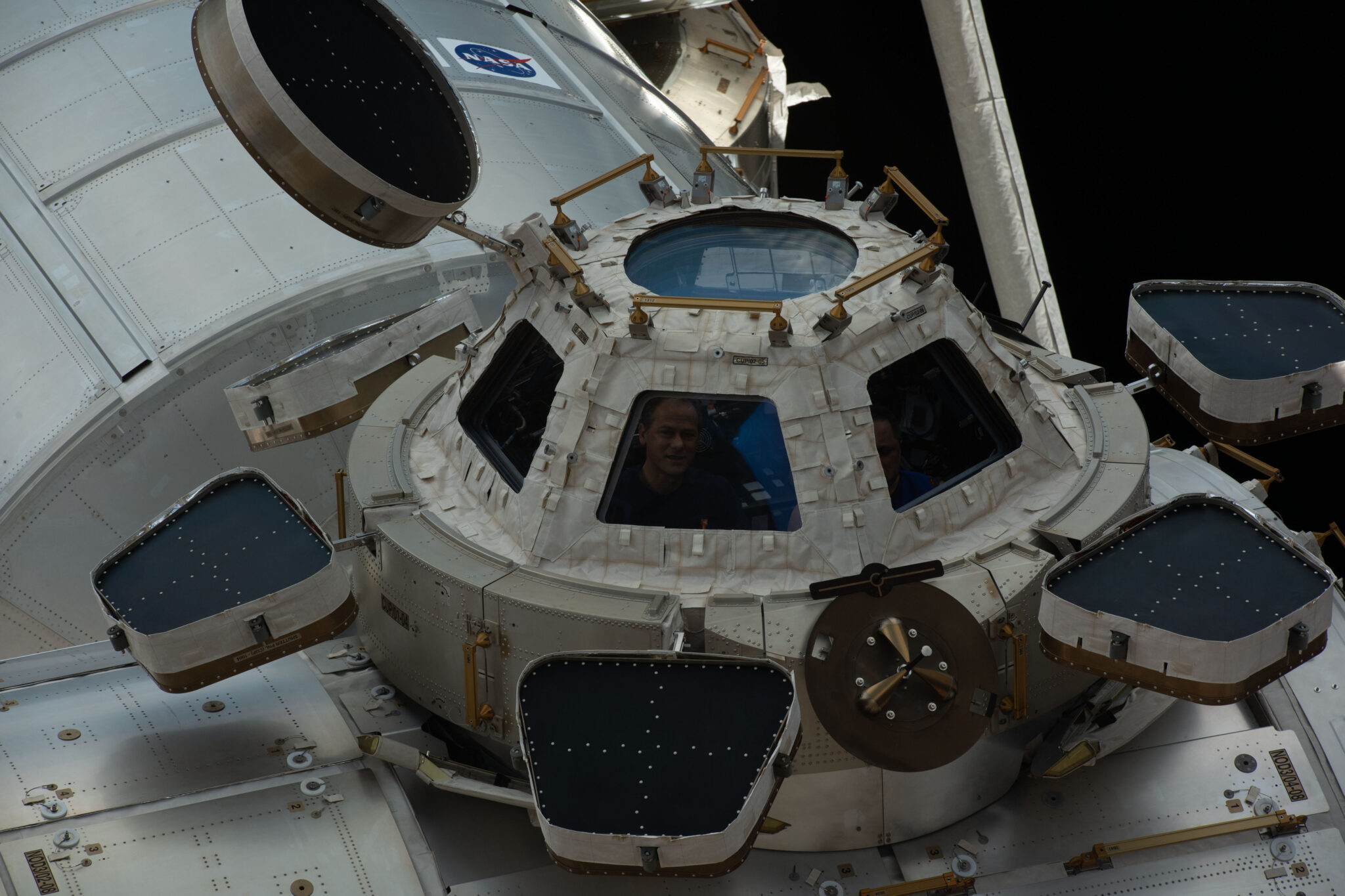 NASA astronaut and Expedition 66 Flight Engineer Thomas Marshburn peers ...