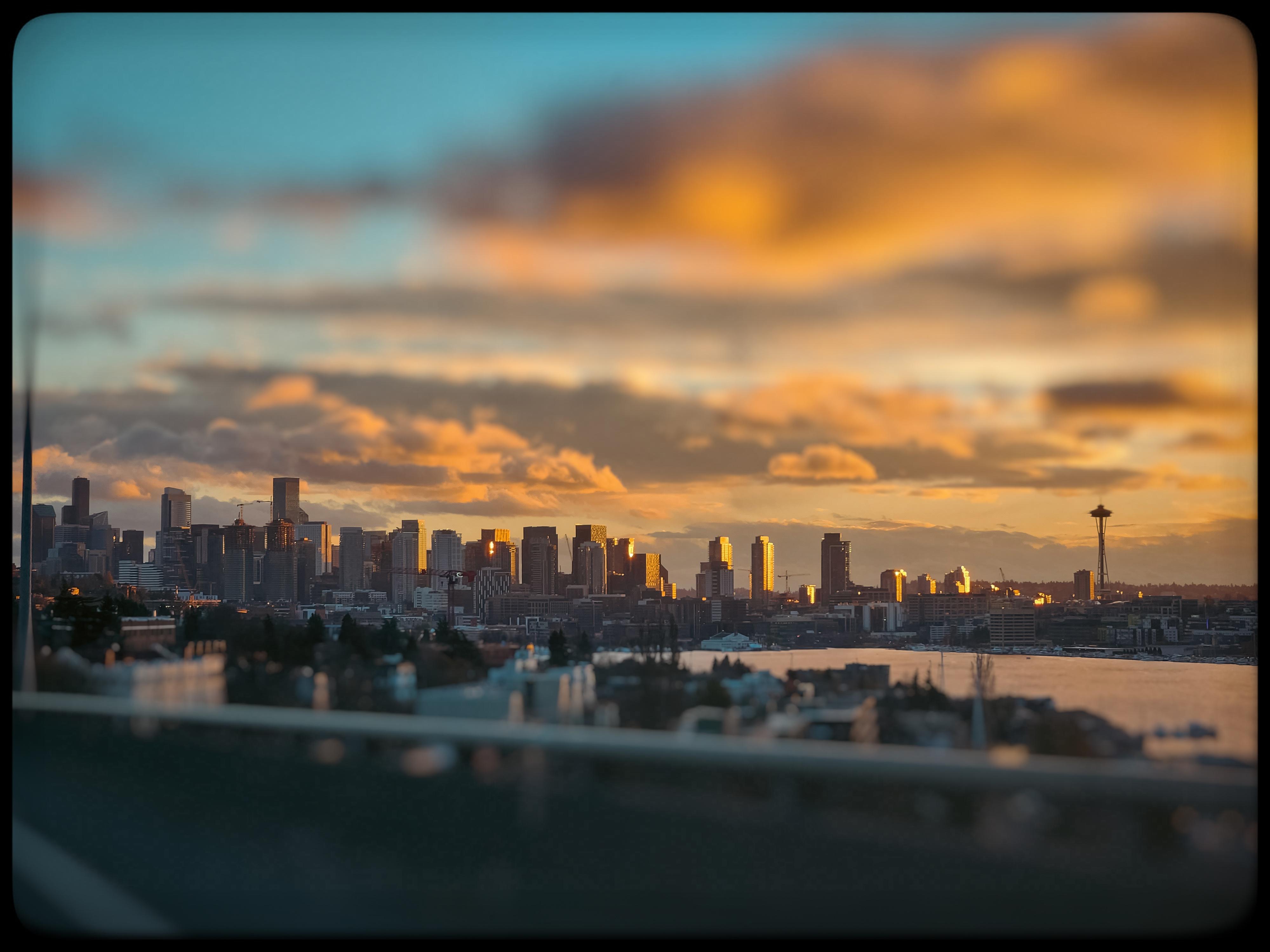 a tilt shift pic of the Seattle skyline during the setting sun taken on ...