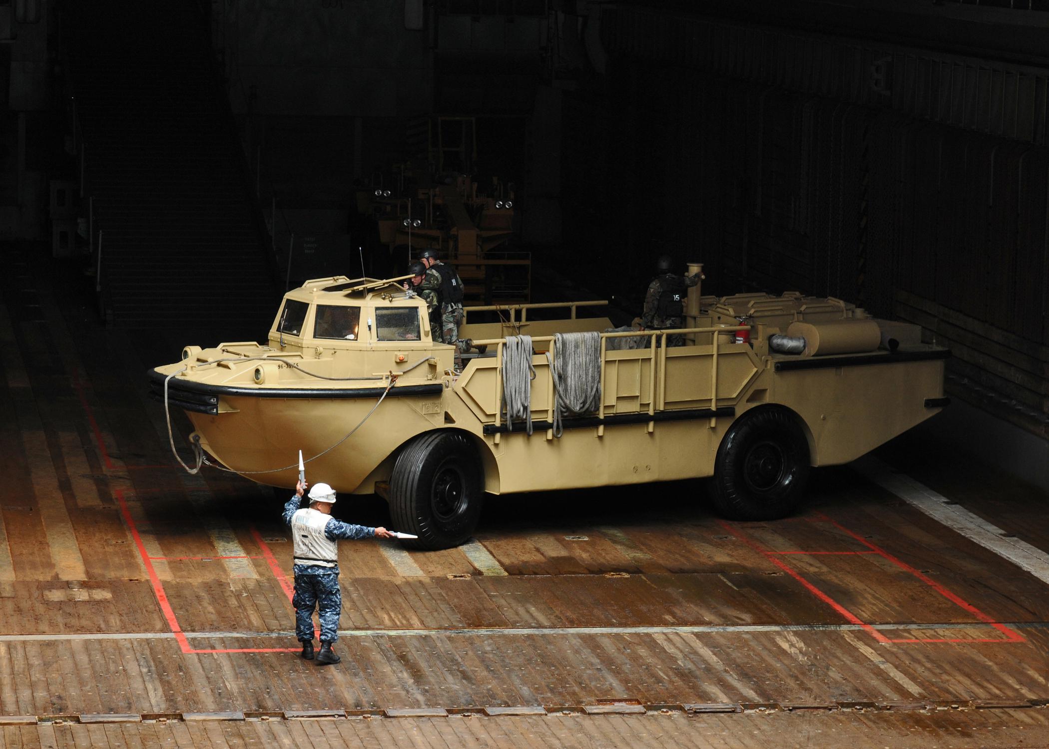 Boatswain’s Mate guides a LARC-V in the well deck of USS Germantown(LSD ...