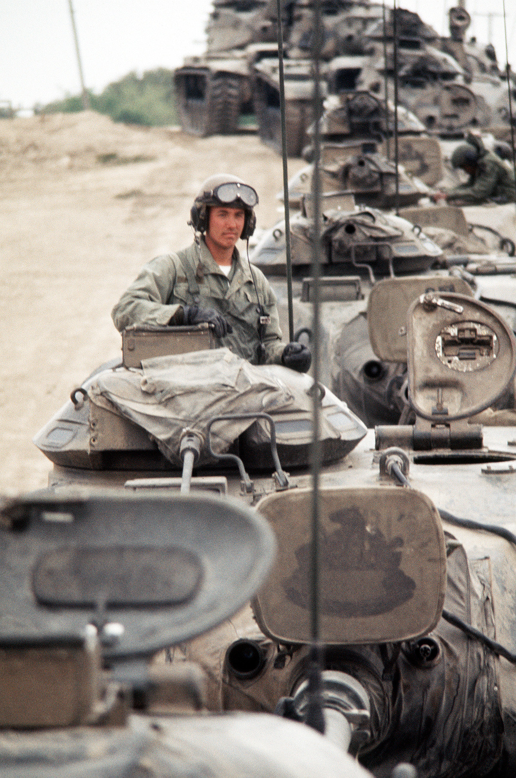 A gunner on an M60 main battle tank looks out a turret during the joint ...